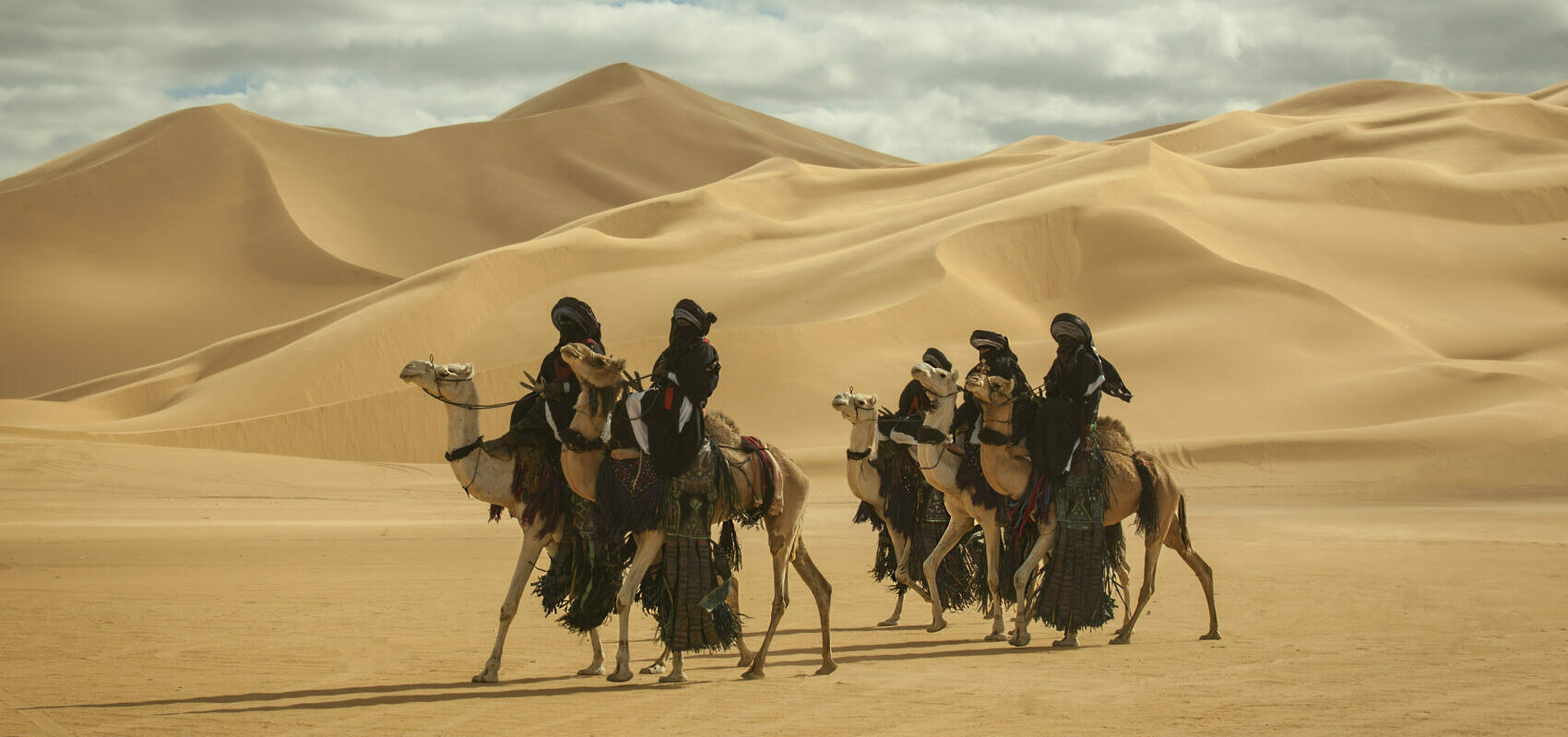 Men riding camels - Globetrender